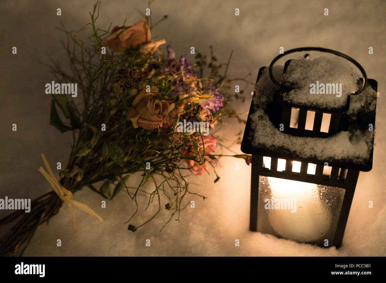 flower bouquet with lantern in snow mourning funeral sad seperation ...