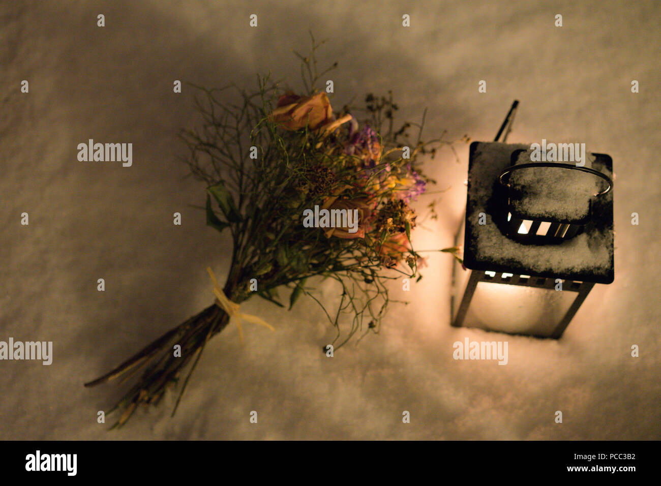 flower bouquet with lantern in snow mourning funeral sad seperation ...