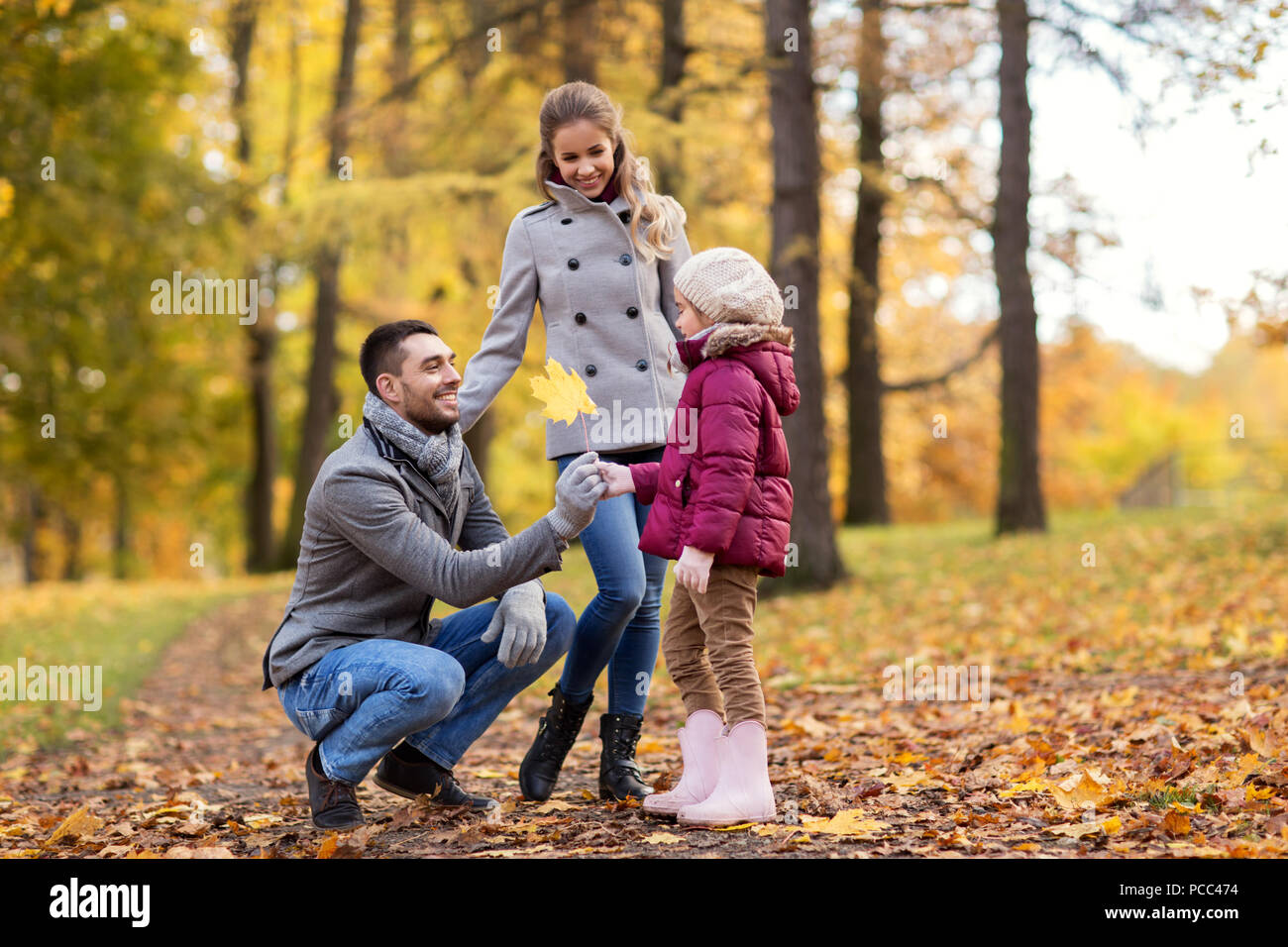 happy family with maple leaf at autumn park Stock Photo - Alamy