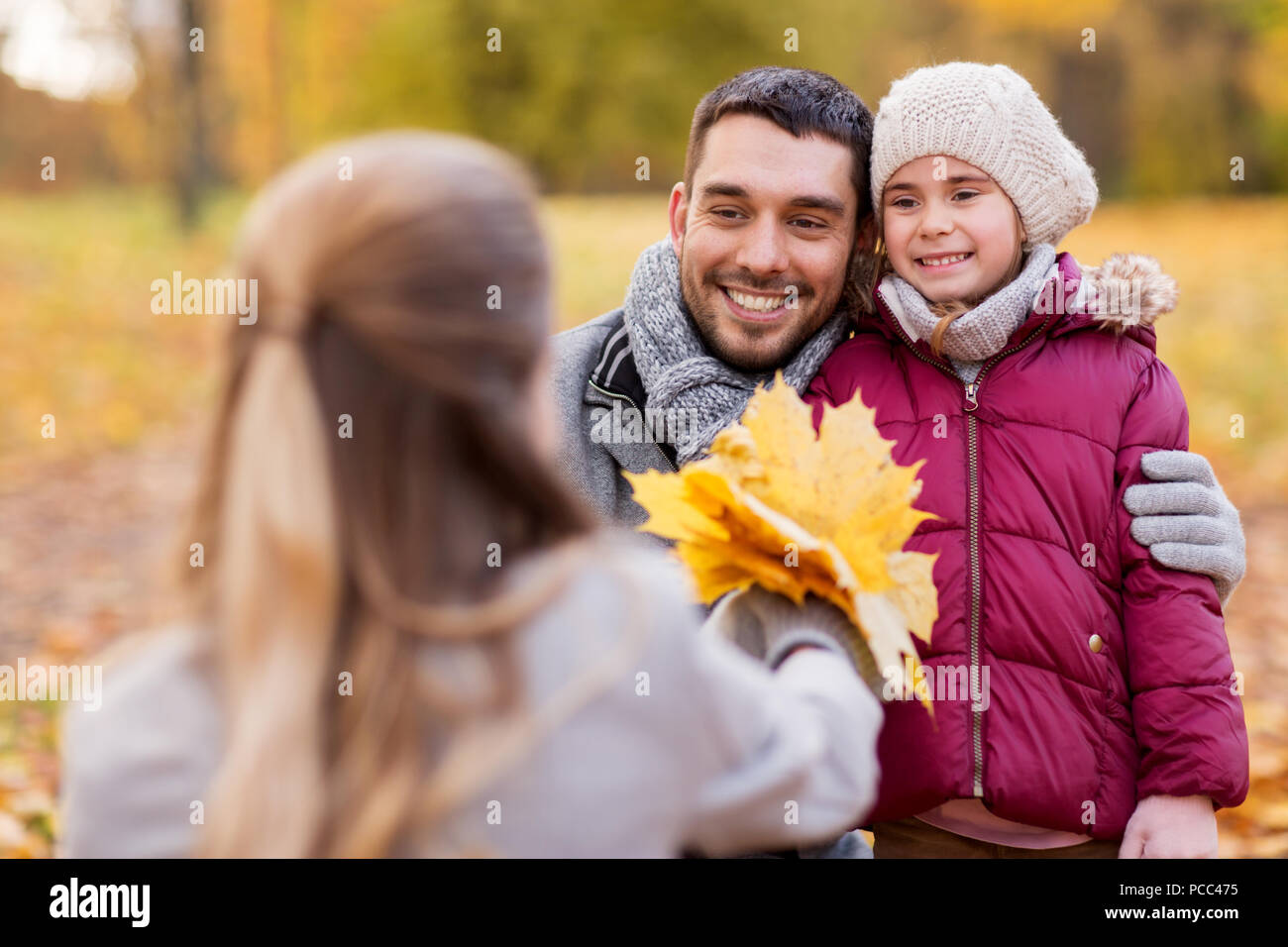 happy family with maple leaves at autumn park Stock Photo - Alamy