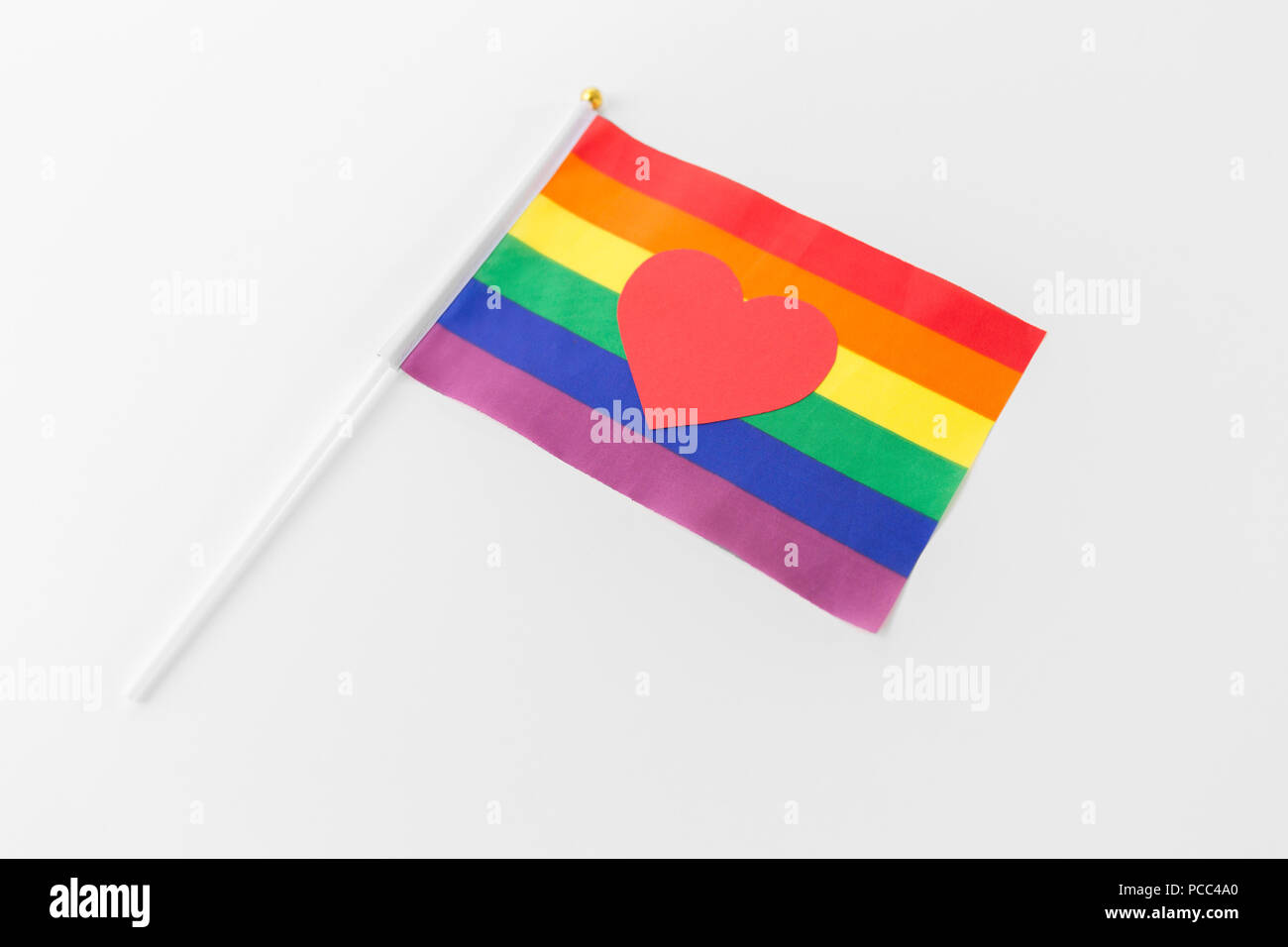 red heart on rainbow flag over white background Stock Photo - Alamy