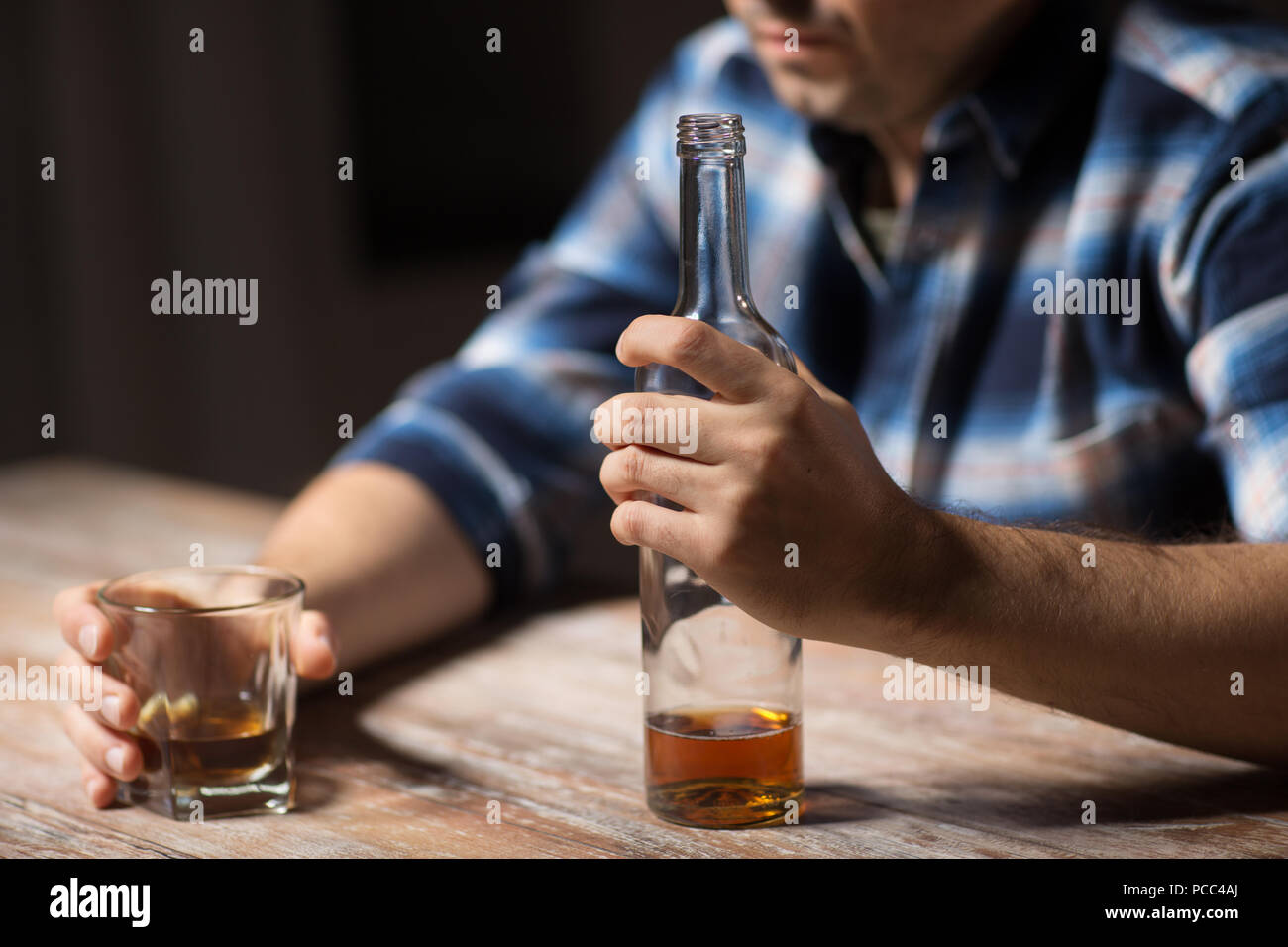 alcoholic with bottle drinking whiskey at night Stock Photo - Alamy