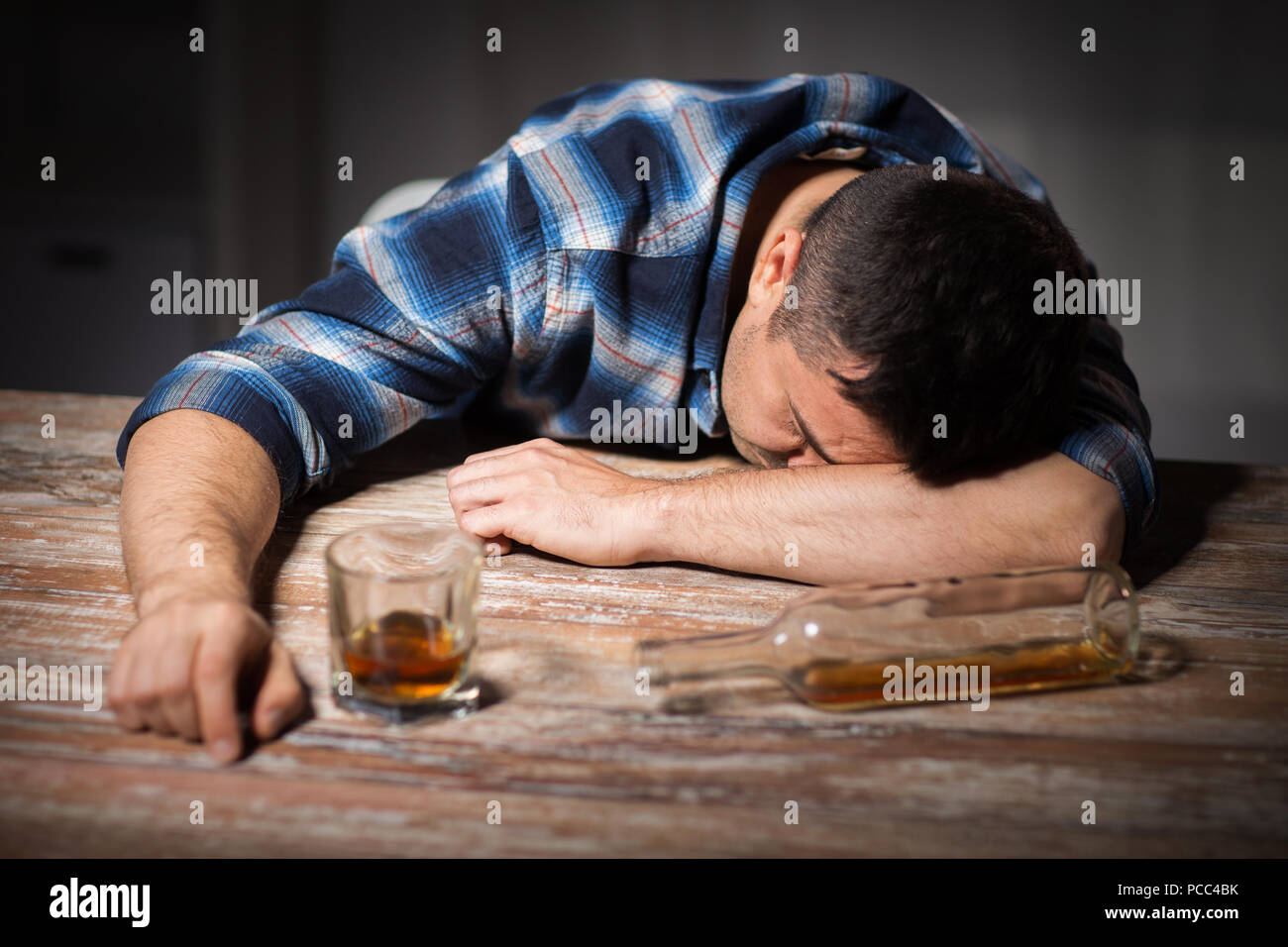 drunk man with glass of alcohol on table at night Stock Photo - Alamy