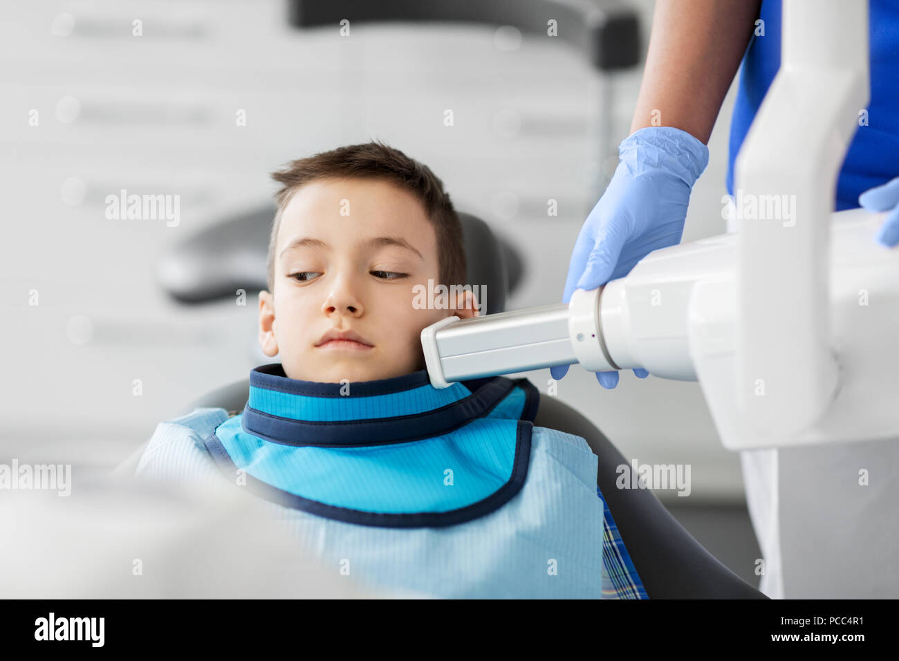 dentist making x-ray of kid teeth at dental clinic Stock Photo - Alamy