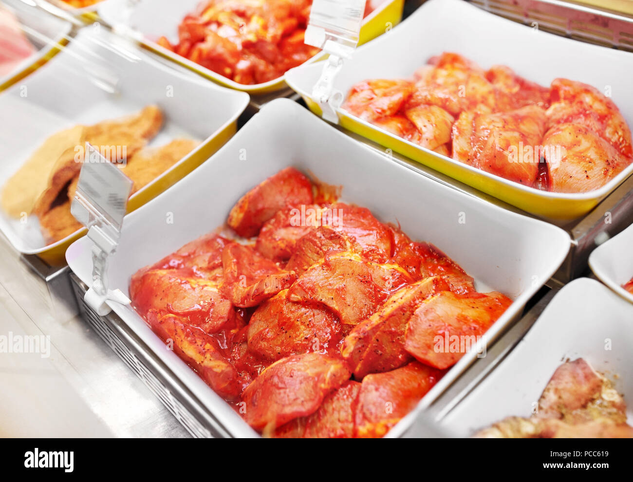 marinated meat in bowls at grocery stall Stock Photo - Alamy