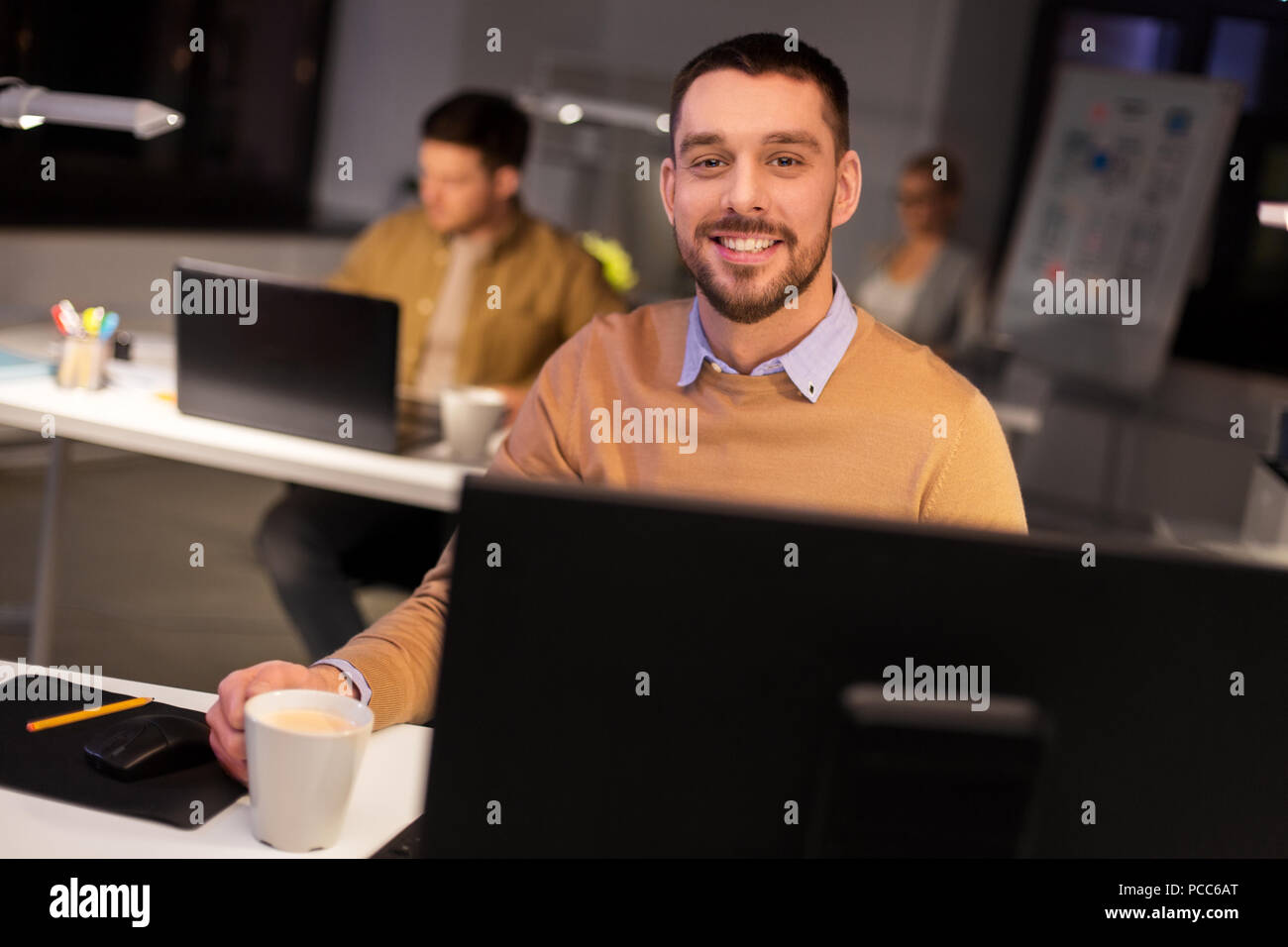 happy male office worker drinking coffee Stock Photo - Alamy
