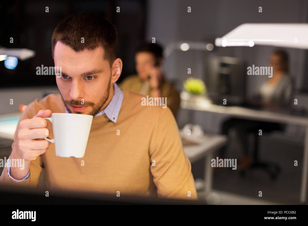 happy male office worker drinking coffee Stock Photo - Alamy