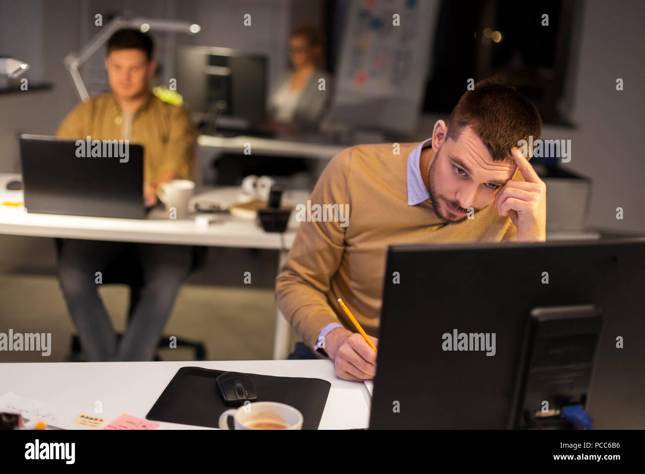 man with computer working late at night office Stock Photo - Alamy
