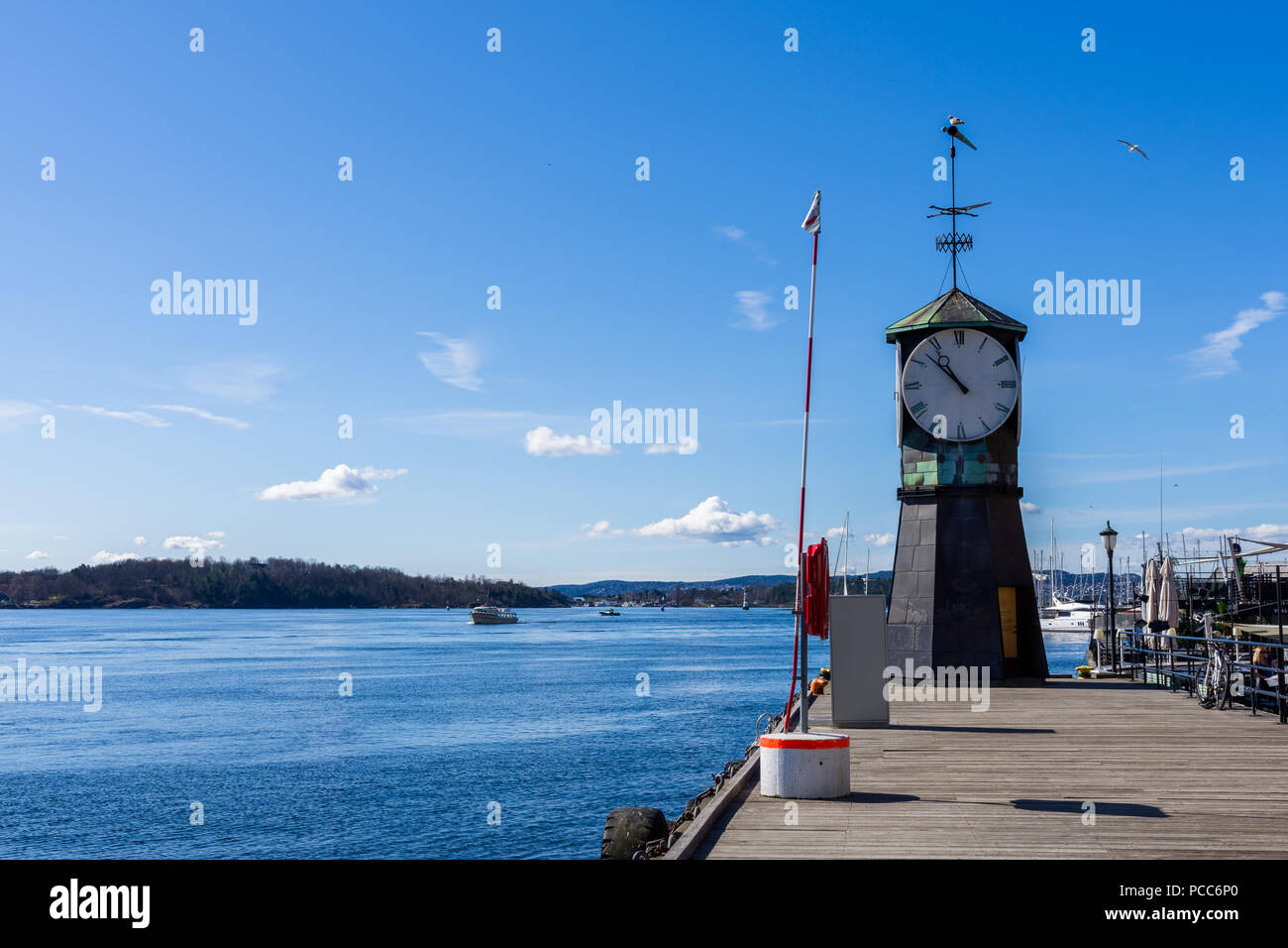 Clock located at the Aker Brygge pier on a beautiful, sunny spring day ...