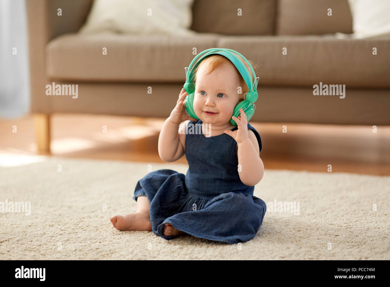 redhead baby girl in headphones listening to music Stock Photo - Alamy