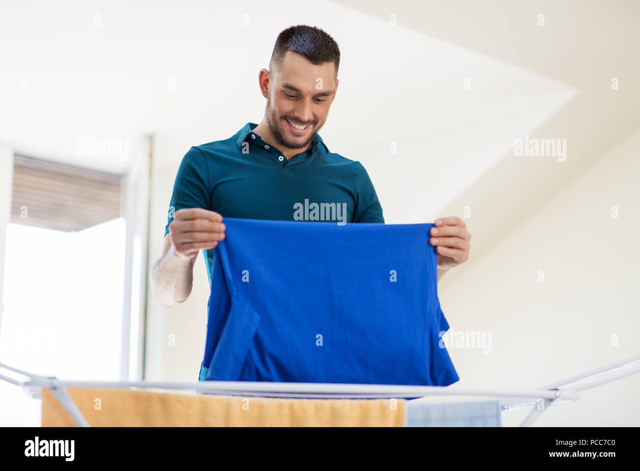 Folding clothes laundry male hi-res stock photography and images - Alamy