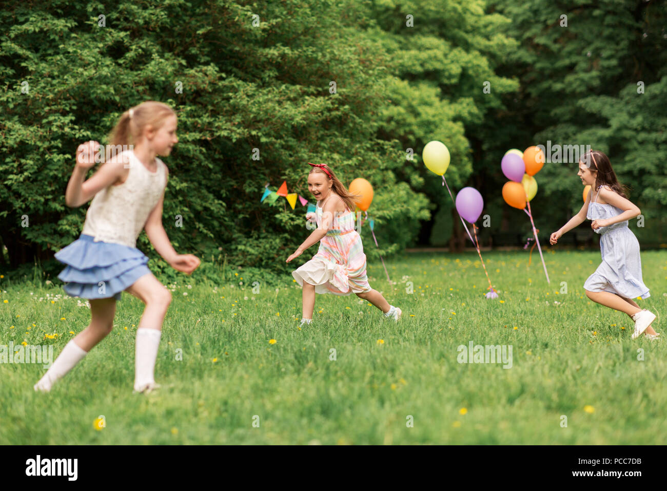 happy girls playing tag game at birthday party Stock Photo - Alamy