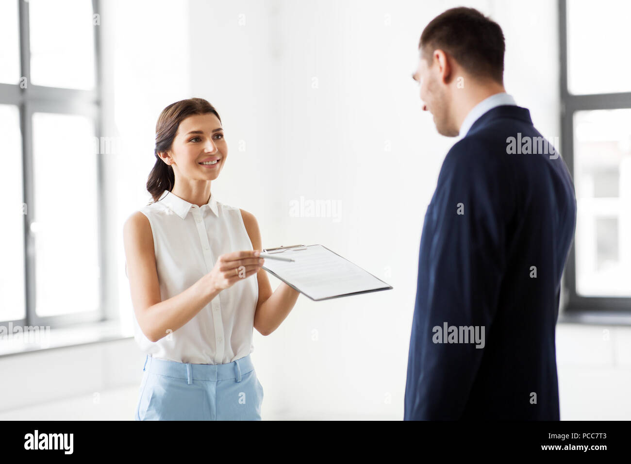 realtor showing contract document to customer Stock Photo - Alamy