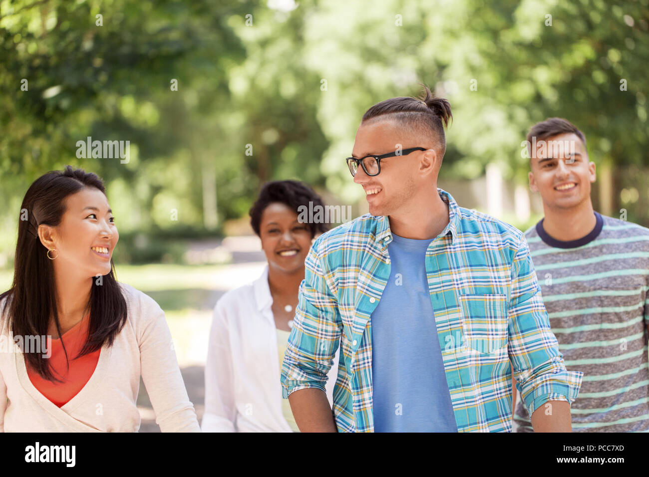 Young college friends talking walking hi-res stock photography and ...