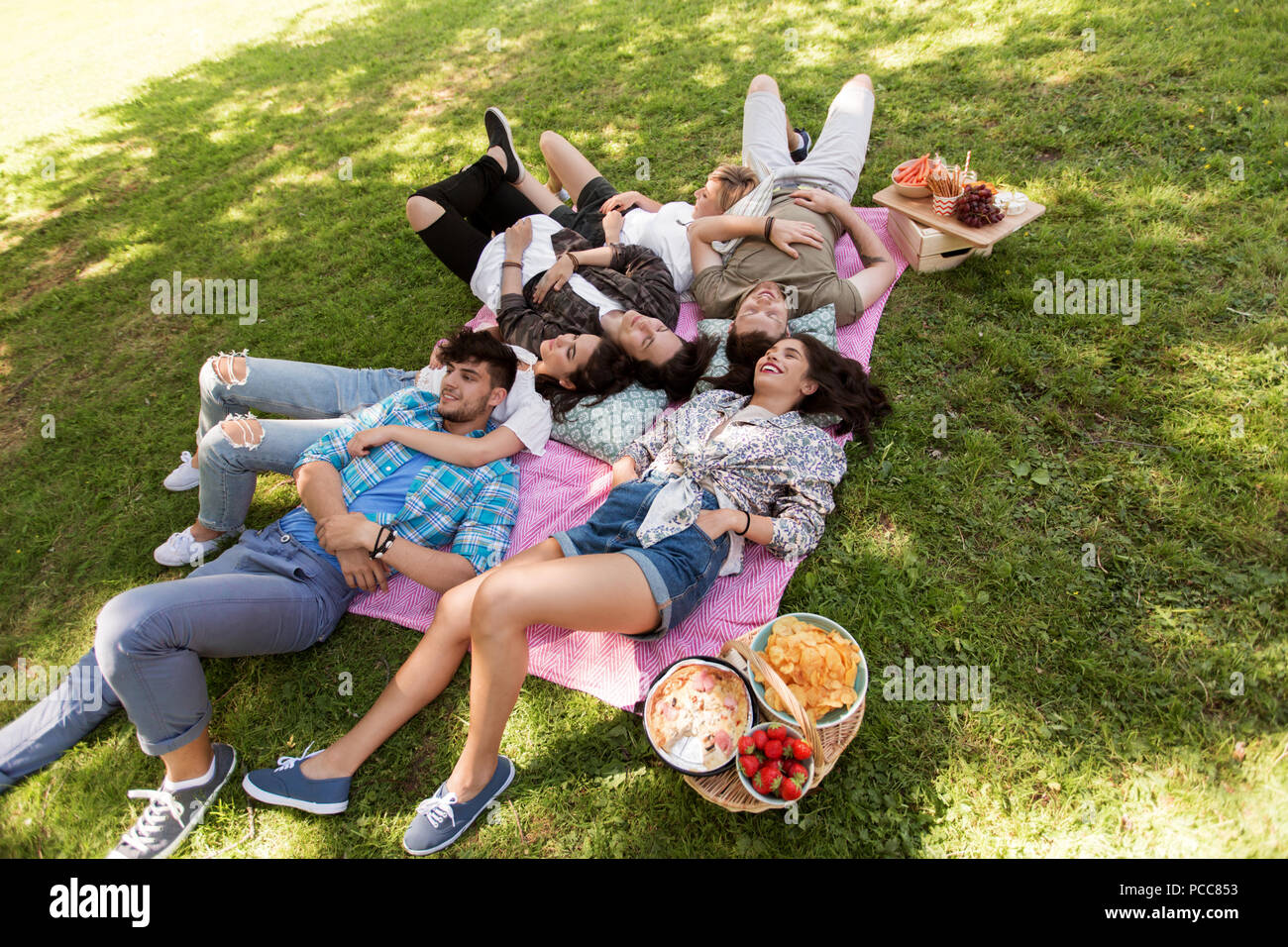 happy friends chilling on picnic blanket at summer Stock Photo - Alamy