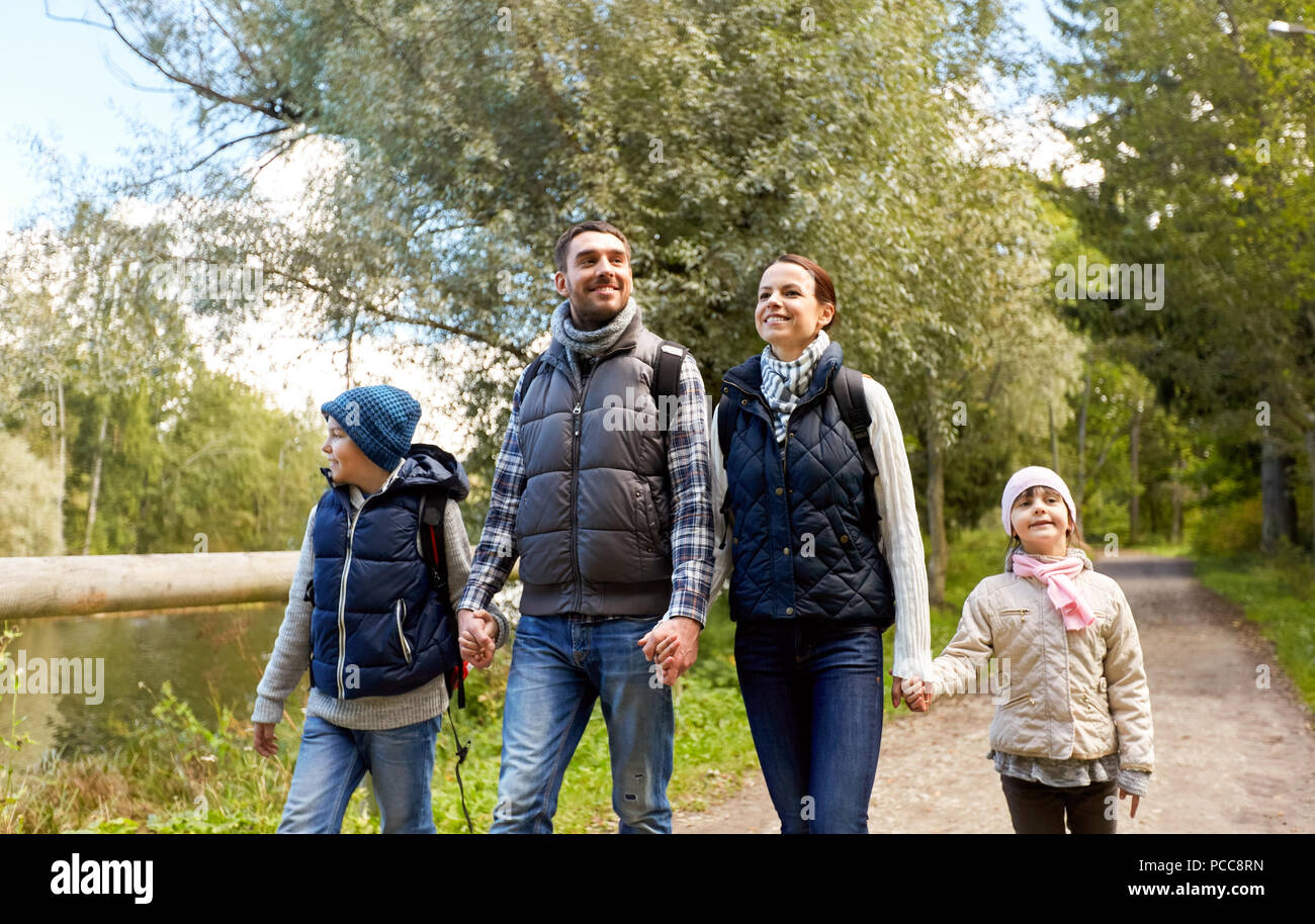 family with backpacks hiking or walking in woods Stock Photo - Alamy