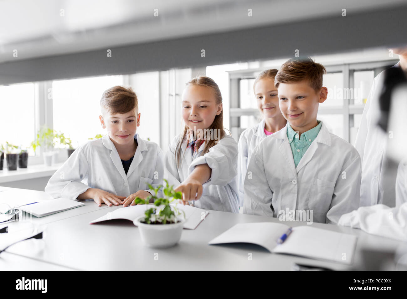 kids or students with plant at biology class Stock Photo - Alamy
