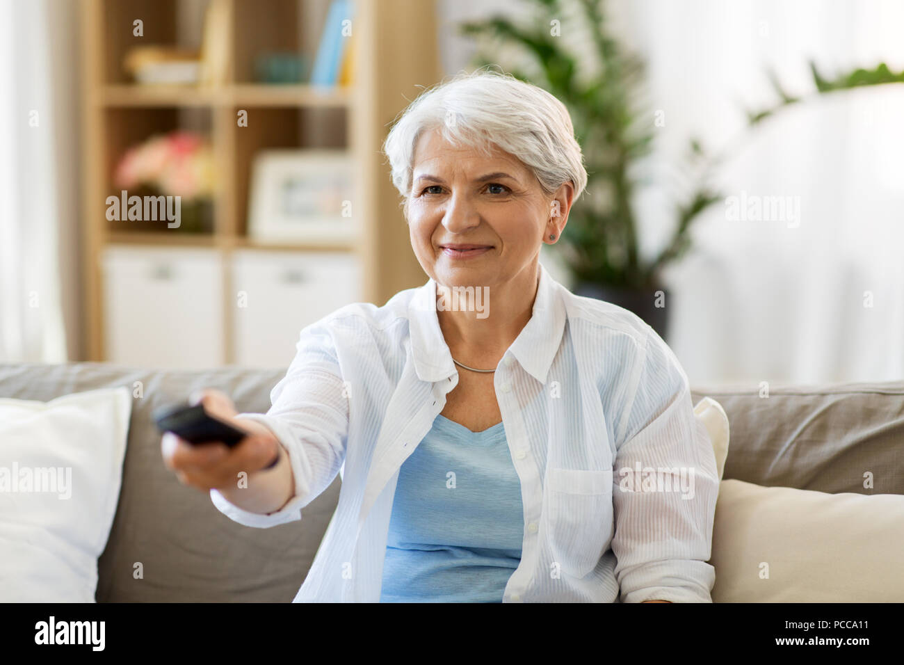 Mature woman and tv remote hi-res stock photography and images - Alamy