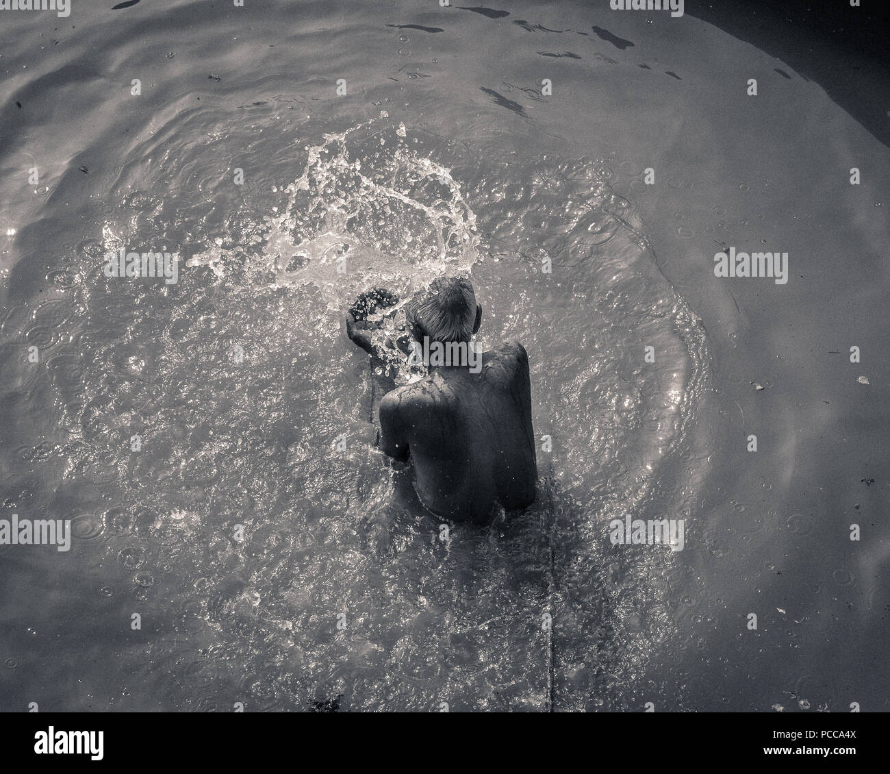 An Indian hindu man worship and taking holy bath in River Ganga at ...