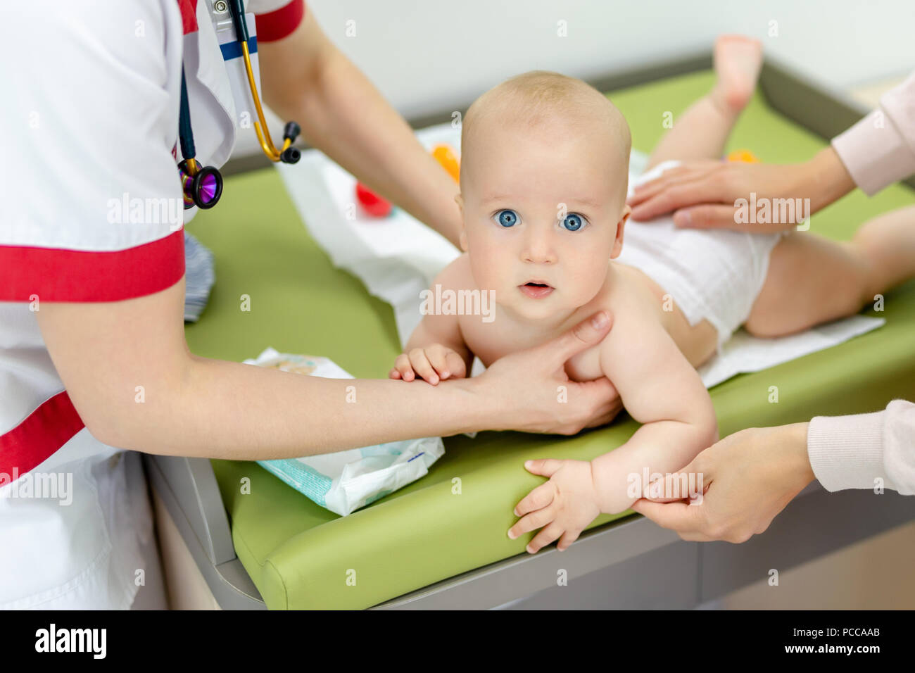 Little cute baby boy visiting doctor . Pediatrician make check up and ...