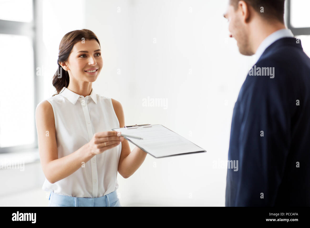 realtor showing contract document to customer Stock Photo - Alamy