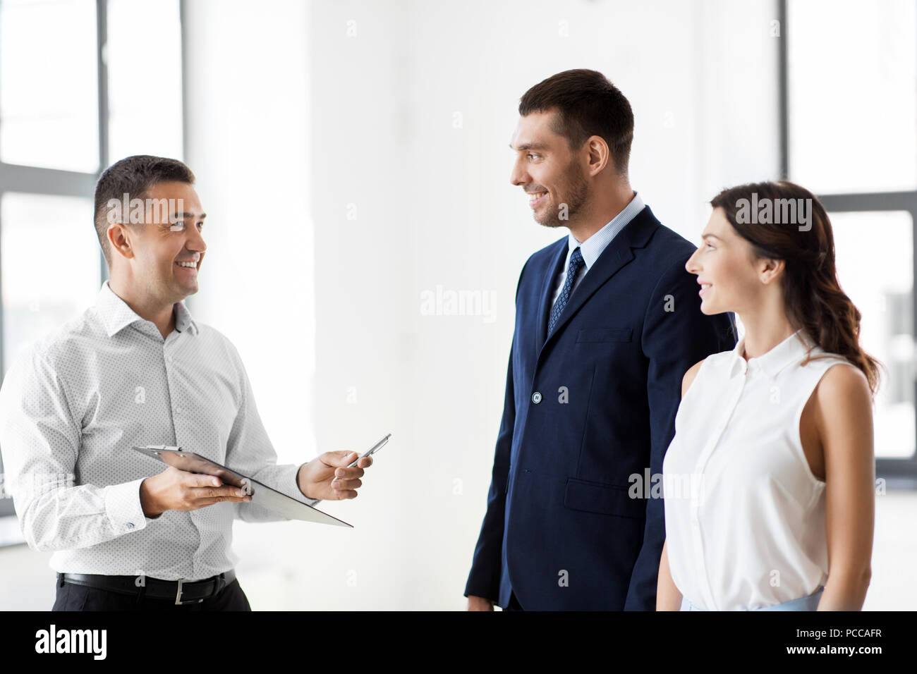 realtor showing contract document to customers Stock Photo - Alamy