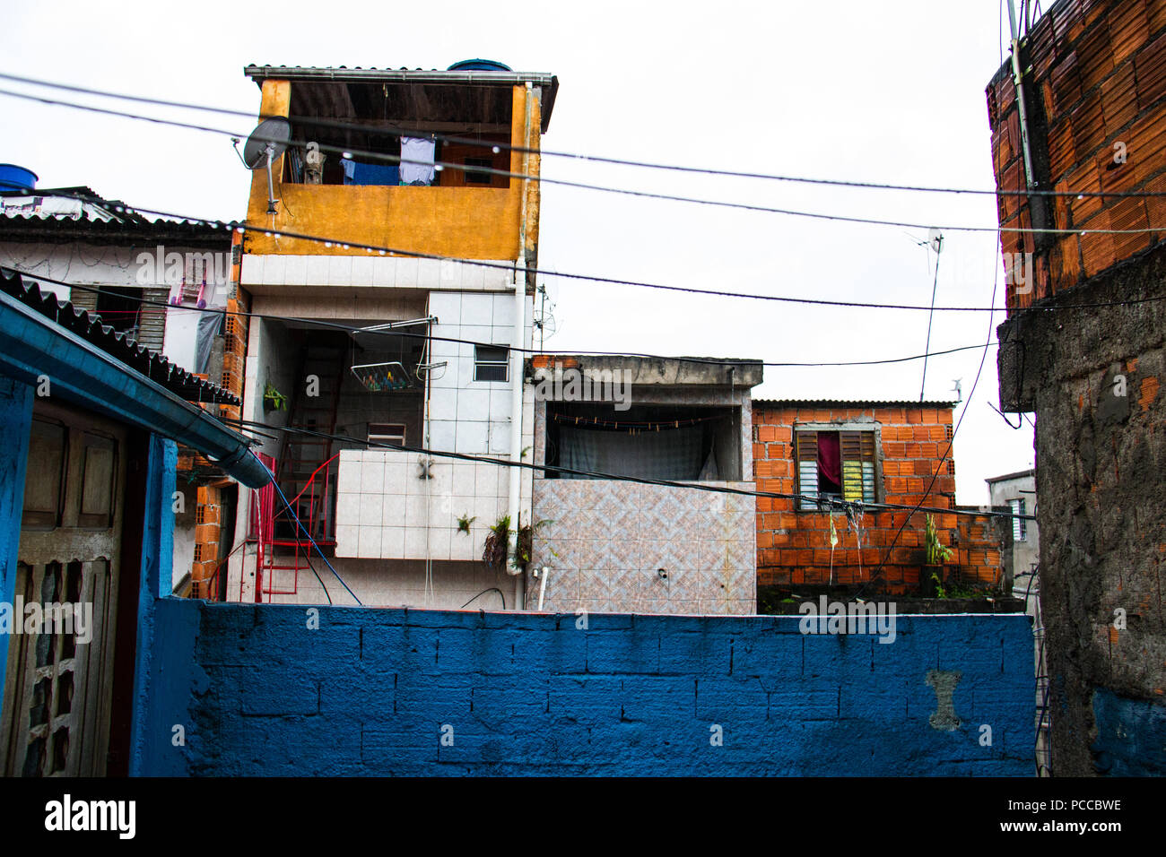 Worn poor concrete and orange brick houses of a favela in San Paolo ...