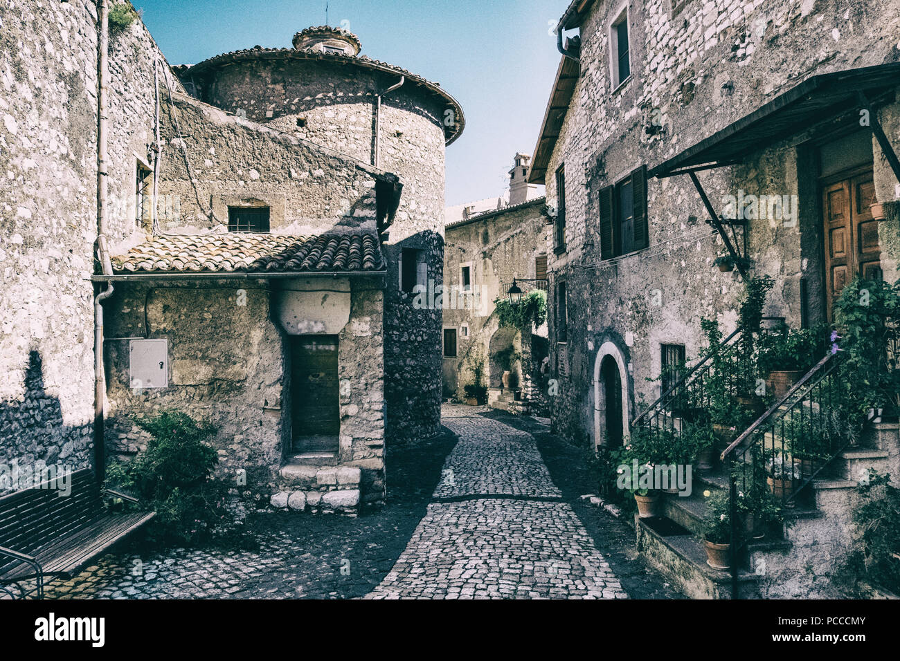 View of an alley with houses of the ancient stone made medieval town of Sermoneta, Italy ...