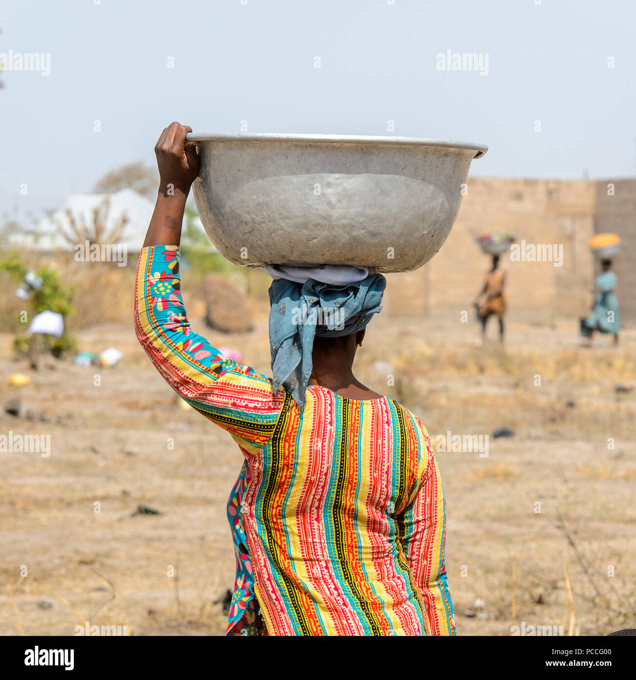 TECHIMAN, GHANA - JAN 15, 2017: Unidentified Ghanaian woman carries a ...