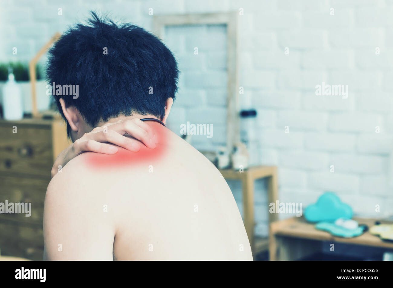 Asian man back pain and sit on bed in bedroom in the morning.color tone ...