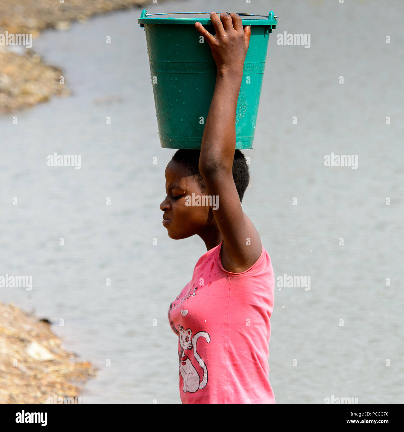 TECHIMAN, GHANA - JAN 15, 2017: Unidentified Ghanaian girl carries a ...