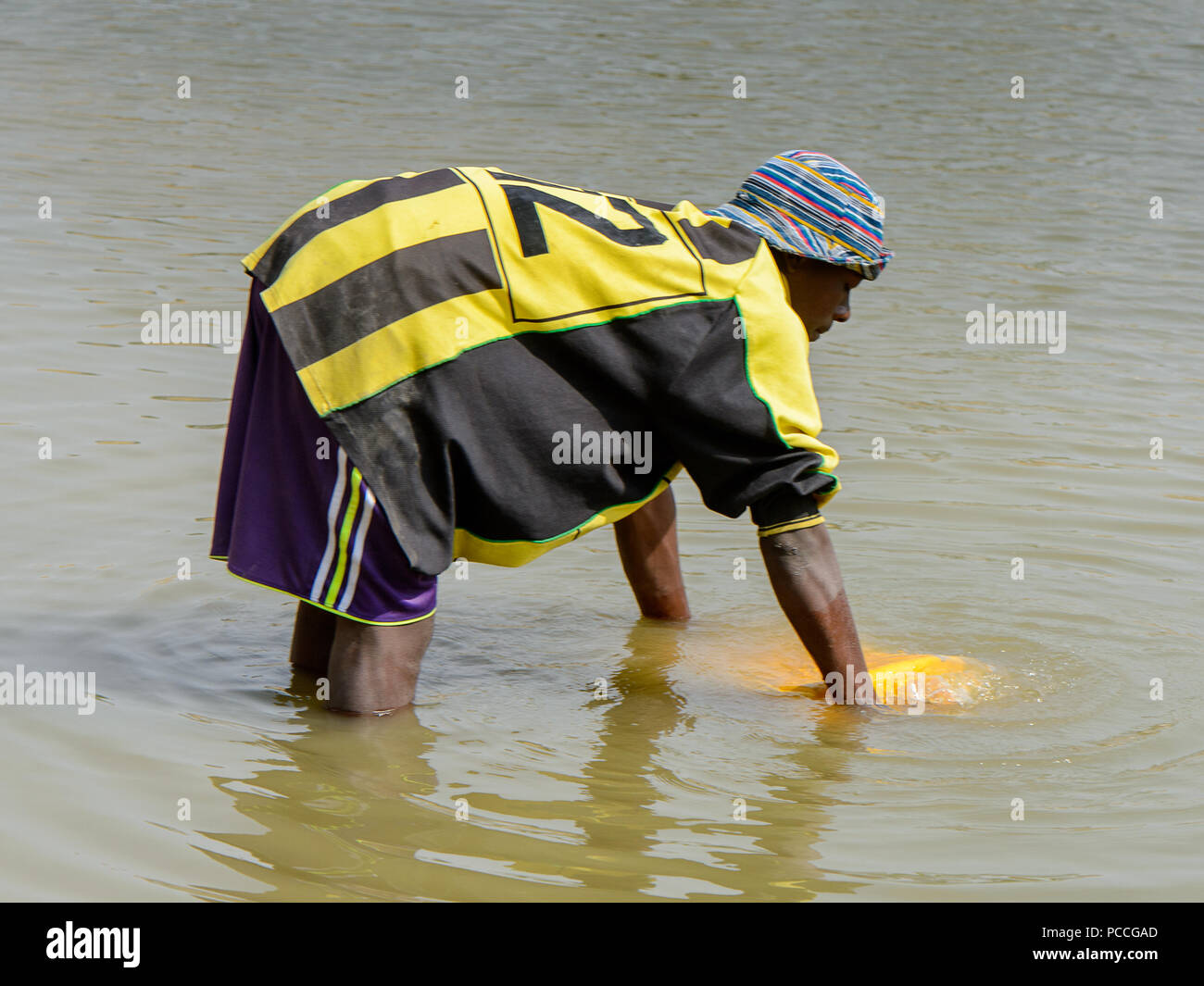 TECHIMAN, GHANA - JAN 15, 2017: Unidentified Ghanaian man gets water on ...