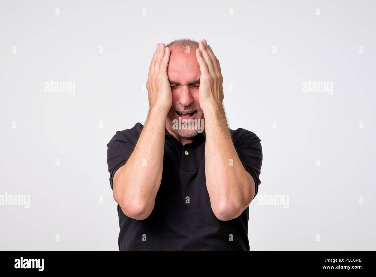 Desperate mature hispanic man crying in his hands Stock Photo - Alamy