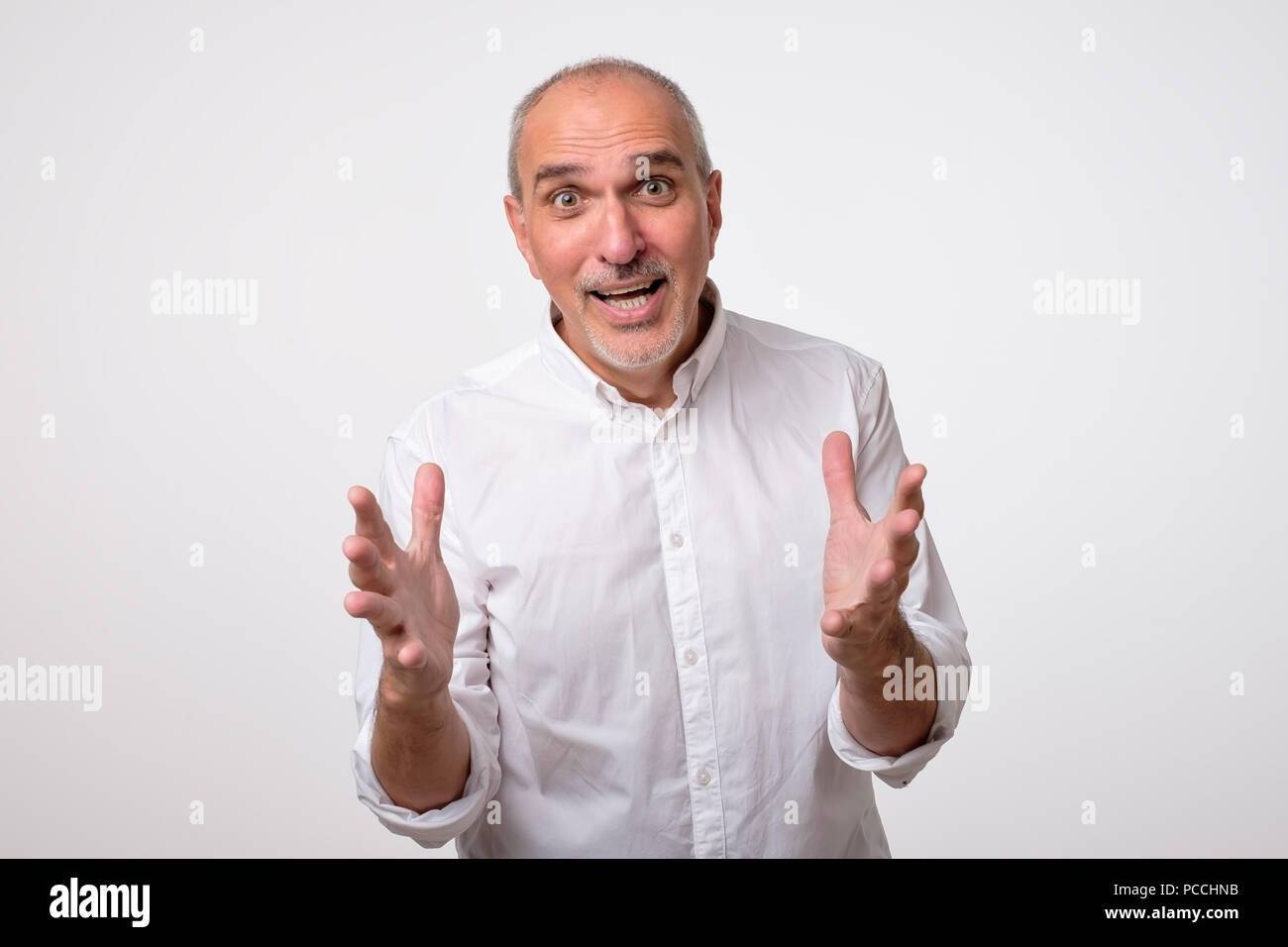 Inspired mature italian man expressing strong emotion while explaining ...