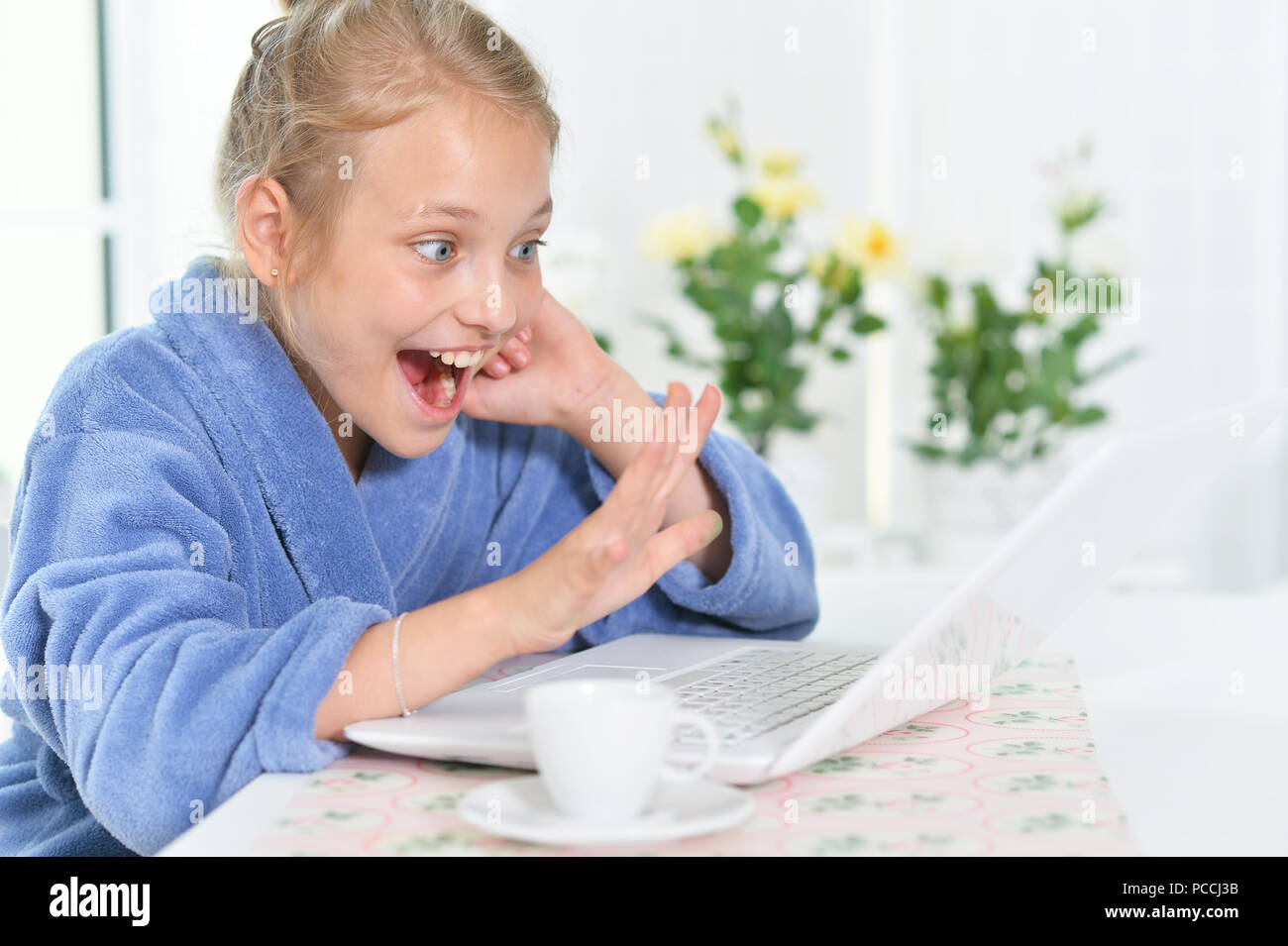 Cute girl wearing blue bathrobe Stock Photo - Alamy