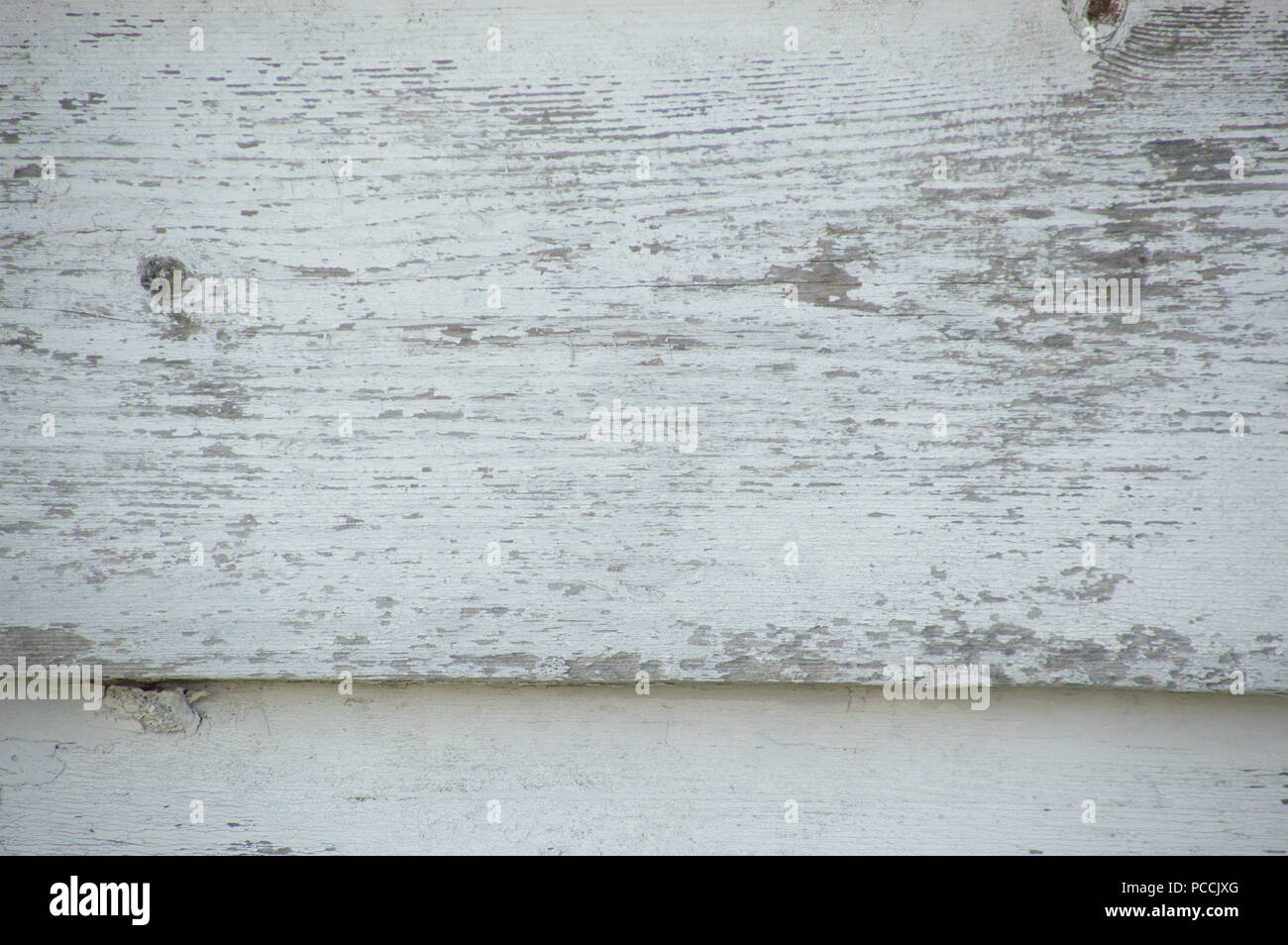 Closeup of grunge white painted boards that are distressed and worn ...