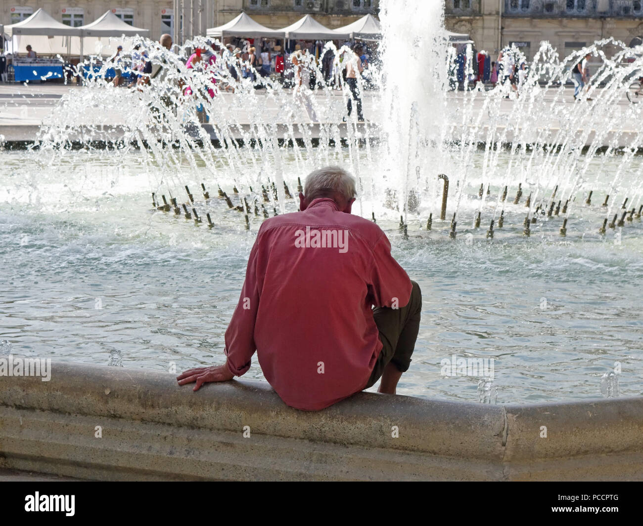 old man feeling hot and uncomfortable in the heatwave tries to keep ...