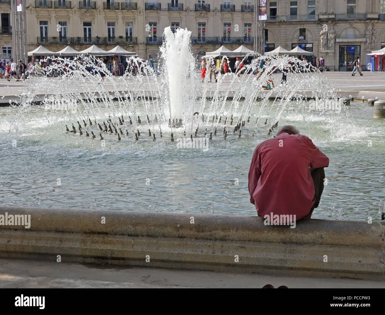 old man feeling hot and uncomfortable in the heatwave tries to keep ...
