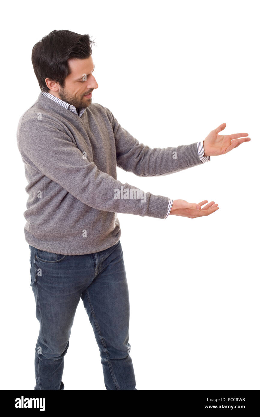 friendly young man pointing to his side. isolated on white background ...