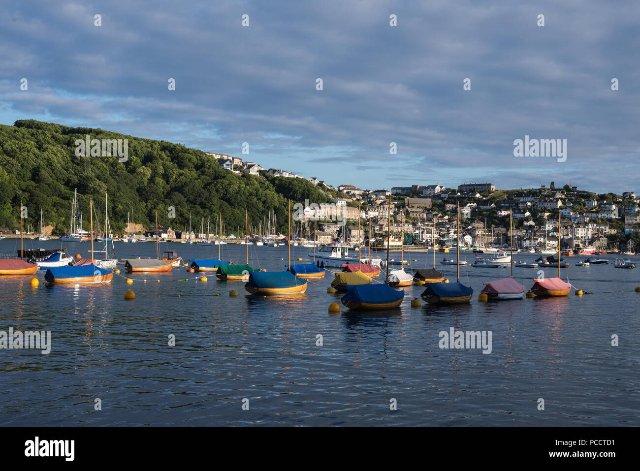 Early Evening Light On A Group Of Sailing Dinghies Moored In Fowey Early Evening Light On A Group Of Sailing Dinghies Moored In Fowey