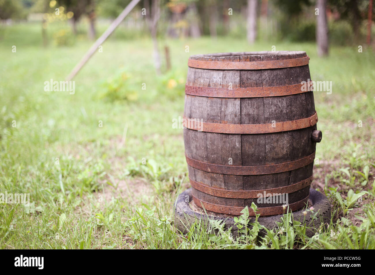 Rusty old barrel in the backyard of a rural house Stock Photo - Alamy
