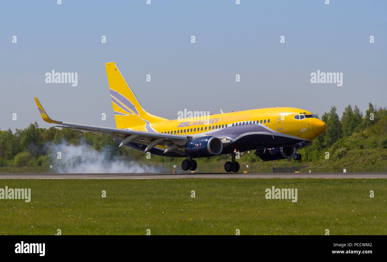 An ASL Airlines flight landing at Manchester Airport Stock Photo - Alamy