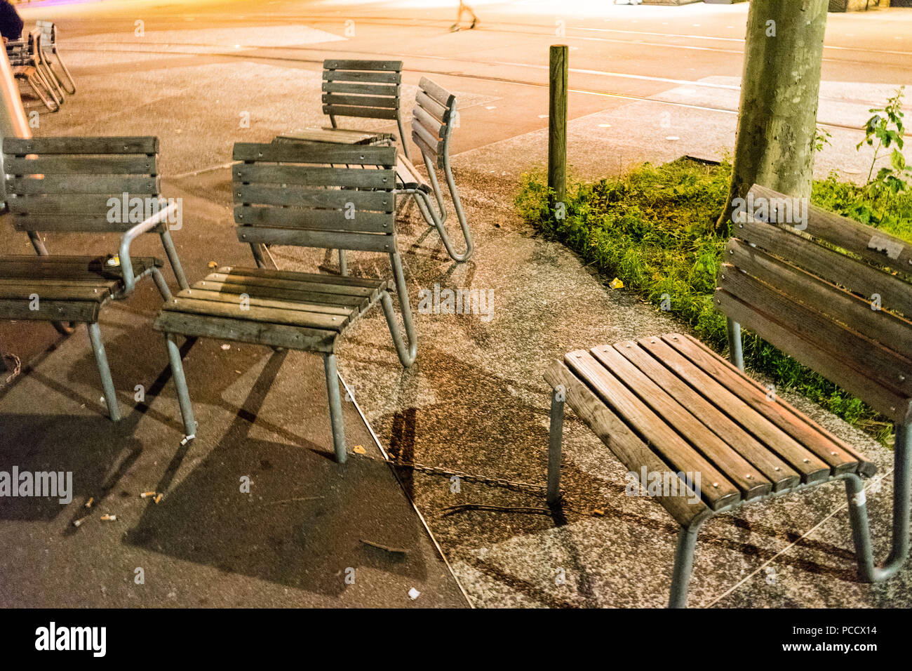 chairs standing randomly around in the night urban Stock Photo - Alamy