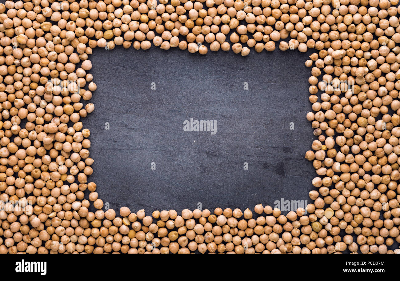 Frame of dried chickpeas on a dark surface, top view Stock Photo - Alamy