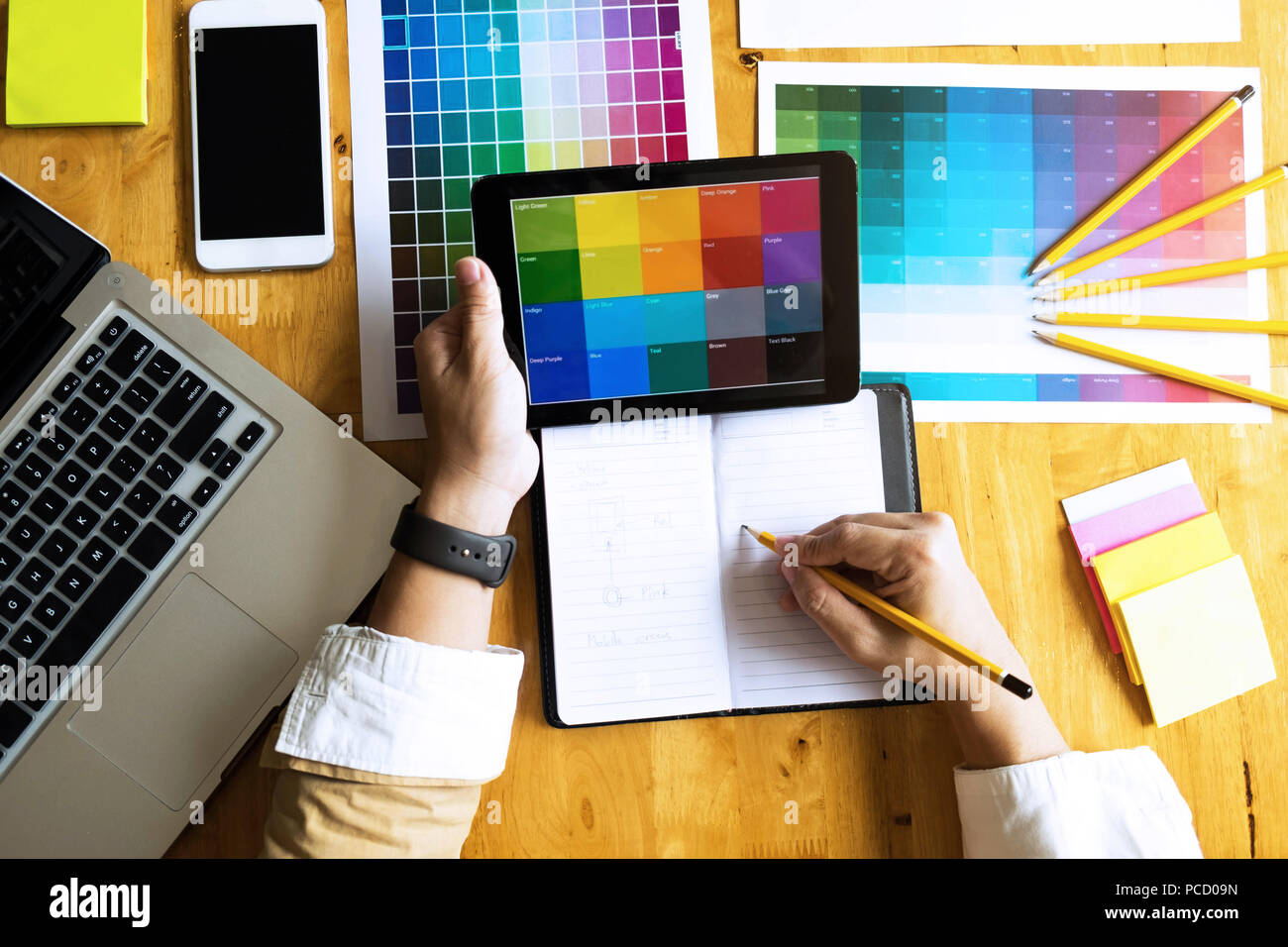 Graphic designers use the tablet to choose colors from the color bar ...