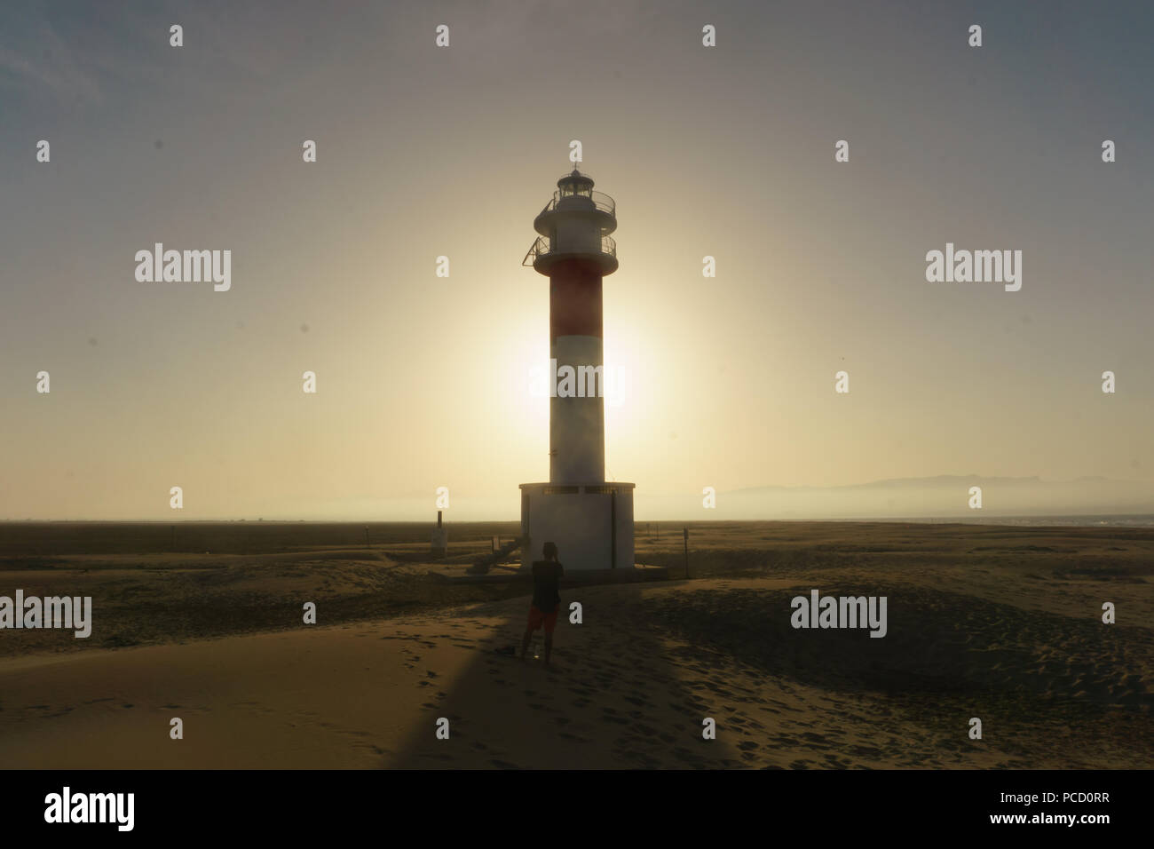 dawn in the desert with a lighthouse Stock Photo - Alamy