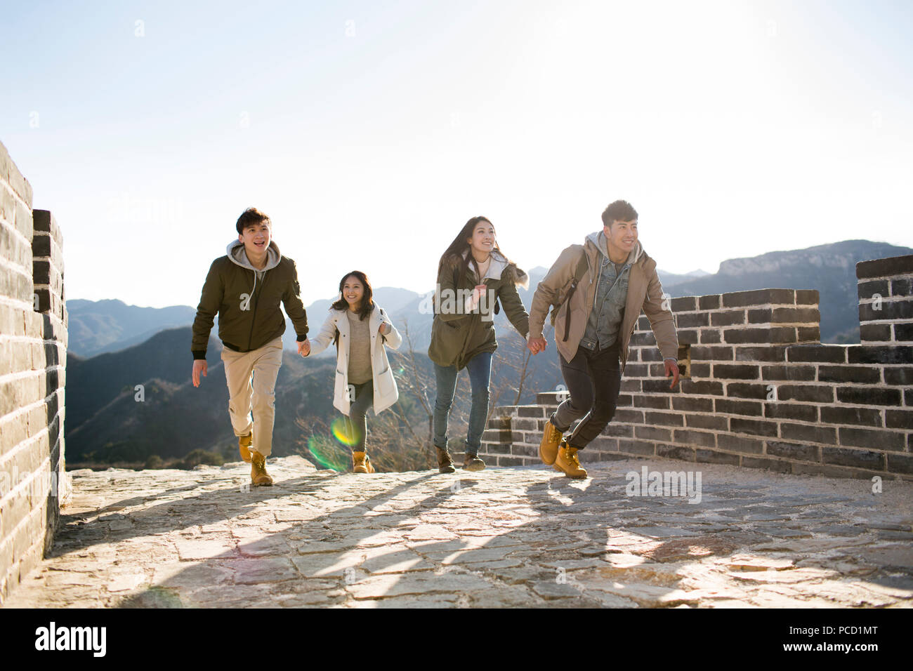 Happy young Chinese friends enjoying winter outing on the Great Wall Stock Photo - Alamy