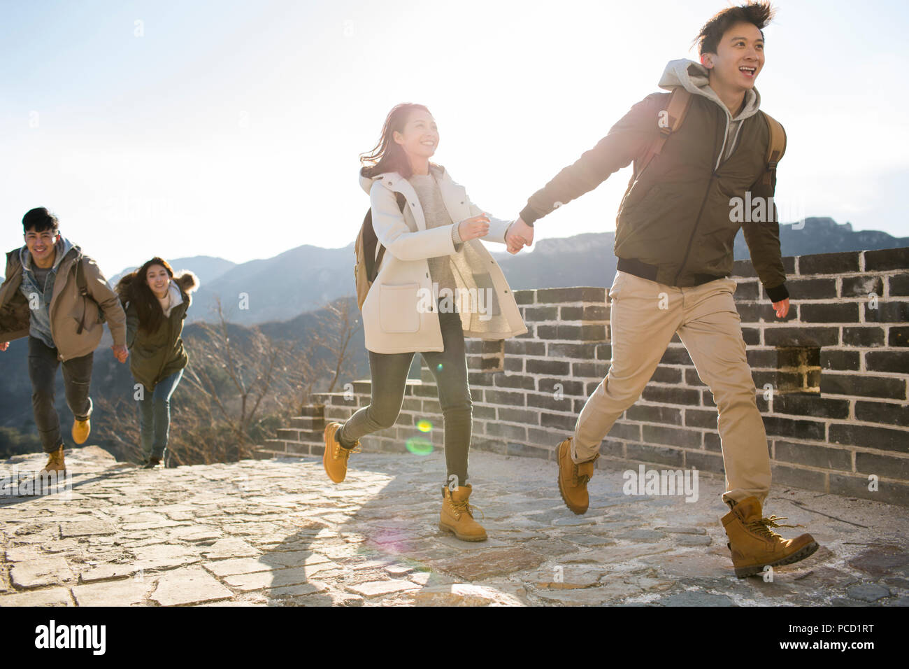 Happy young Chinese friends enjoying winter outing on the Great Wall Stock Photo - Alamy
