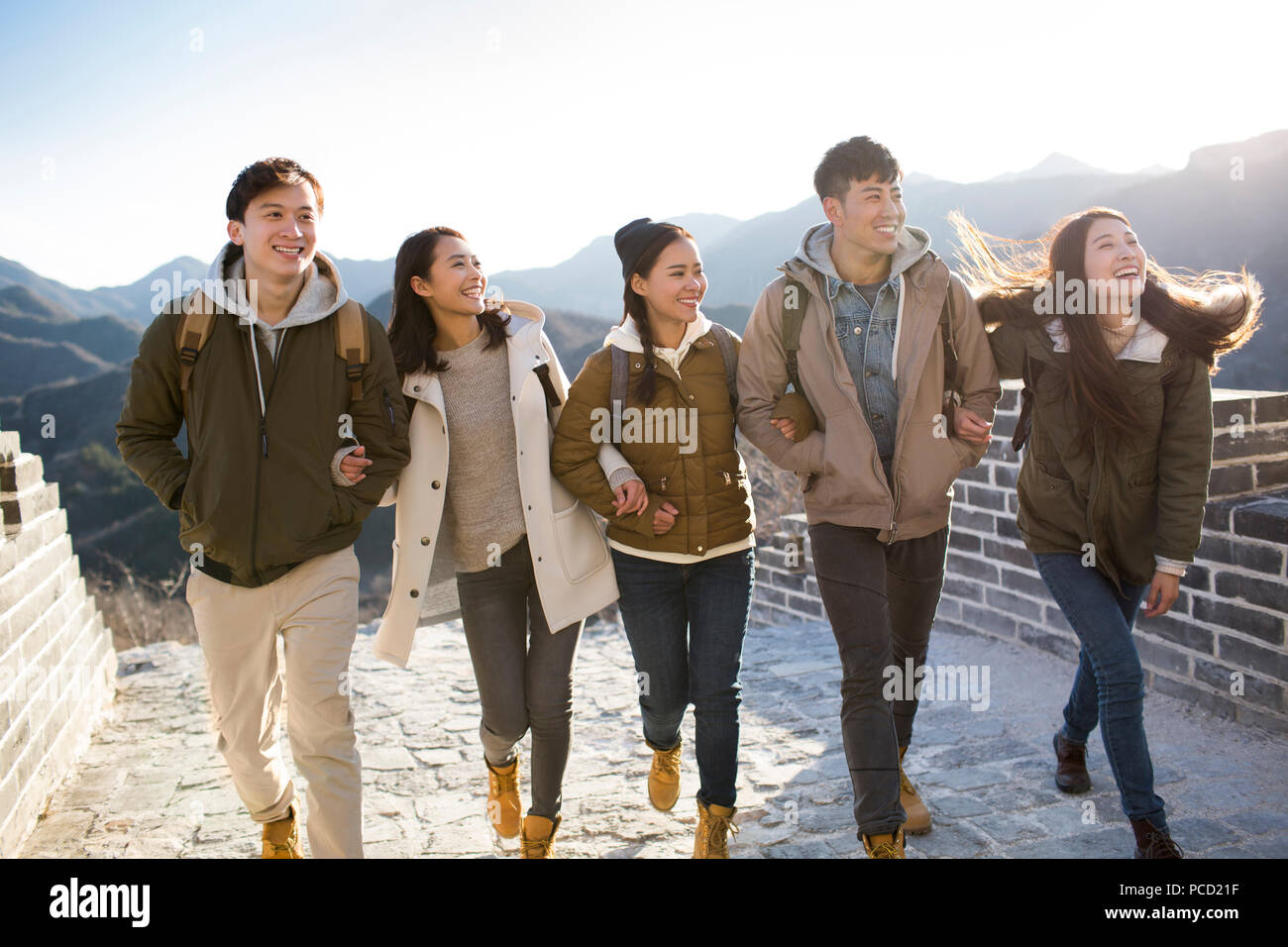 Happy young Chinese friends enjoying winter outing on the Great Wall Stock Photo - Alamy