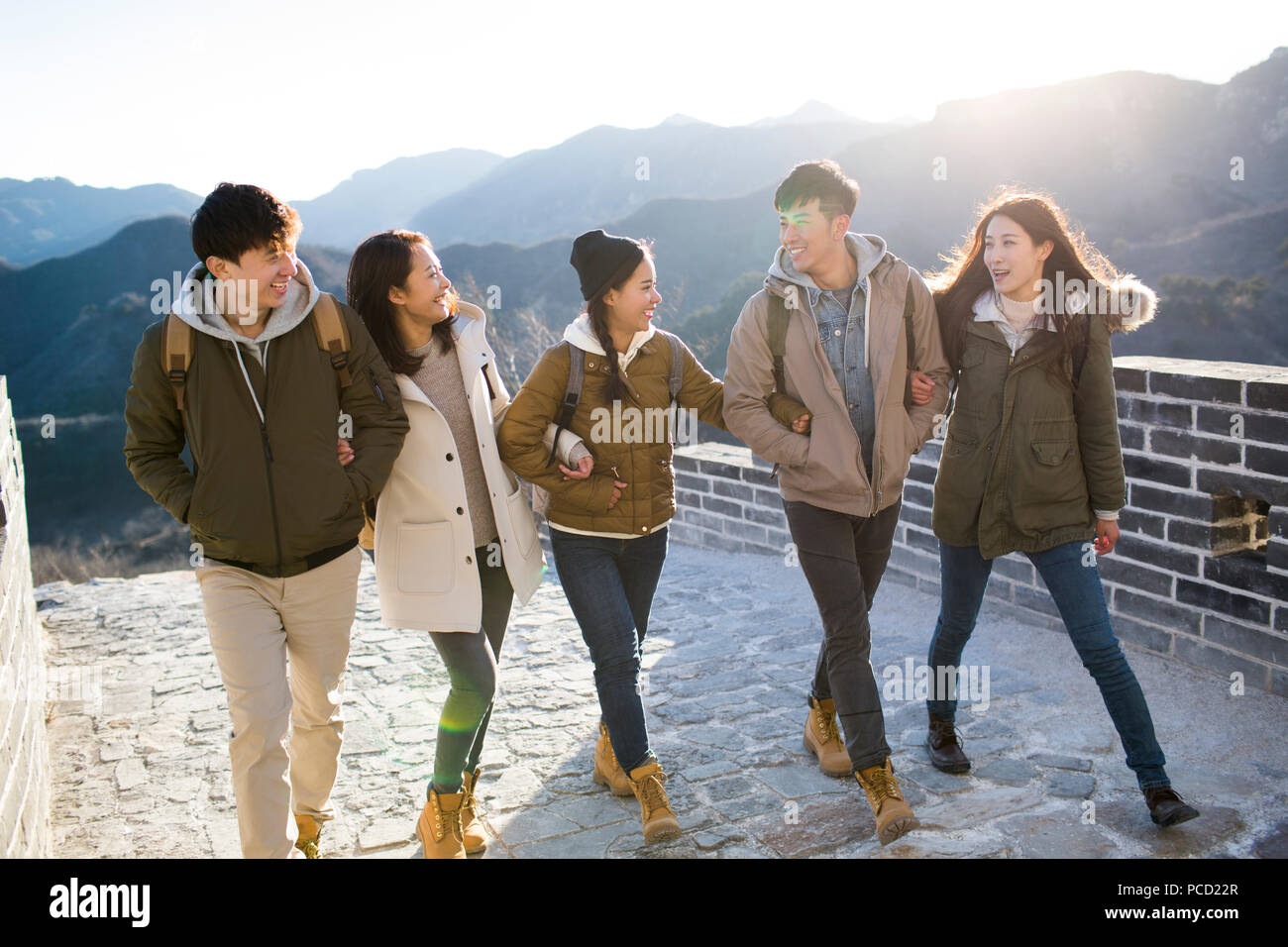 Happy young Chinese friends enjoying winter outing on the Great Wall ...